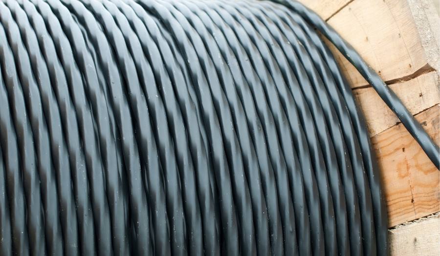How do high-voltage cables develop dangerous sheath voltages?